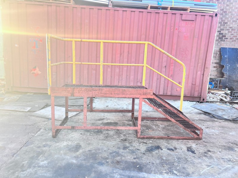 Industrial style metal stairs or a work platform with a handrail ...